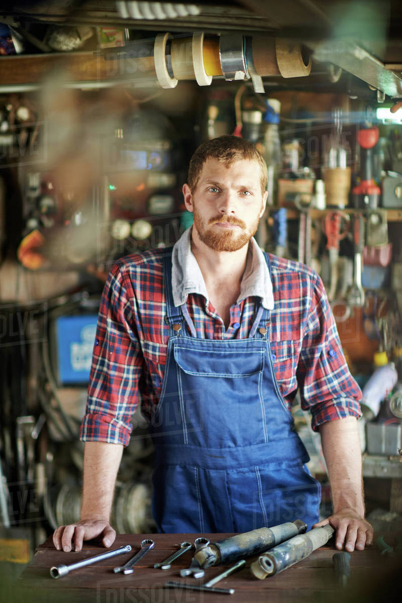 Young serious workman looking at camera - Royalty-free Stock Photo ...