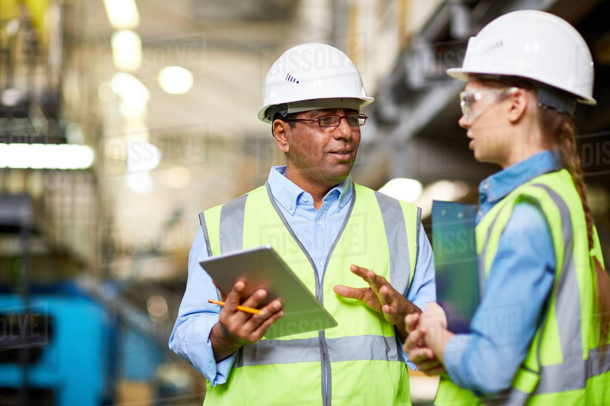 Two engineers discussing work and using tablet pc - Royalty-free Stock ...