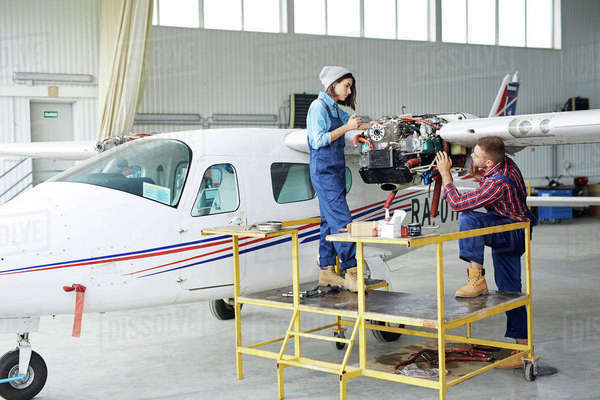 Airplane service staff repairing parts of jet - Royalty-free Stock ...