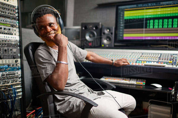 Happy young man sitting in audio studio - Royalty-free Stock Photo ...