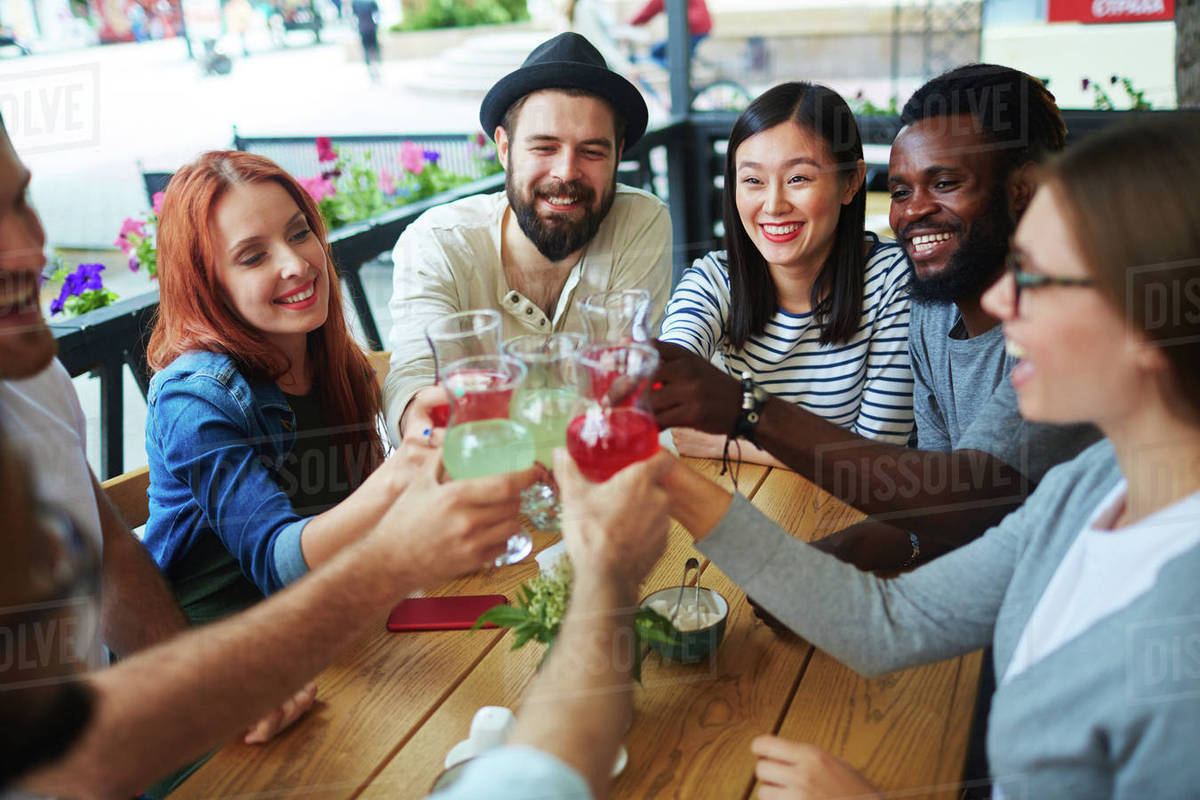 Happy friends toasting with drinks - Royalty-free Stock Photo | Dissolve