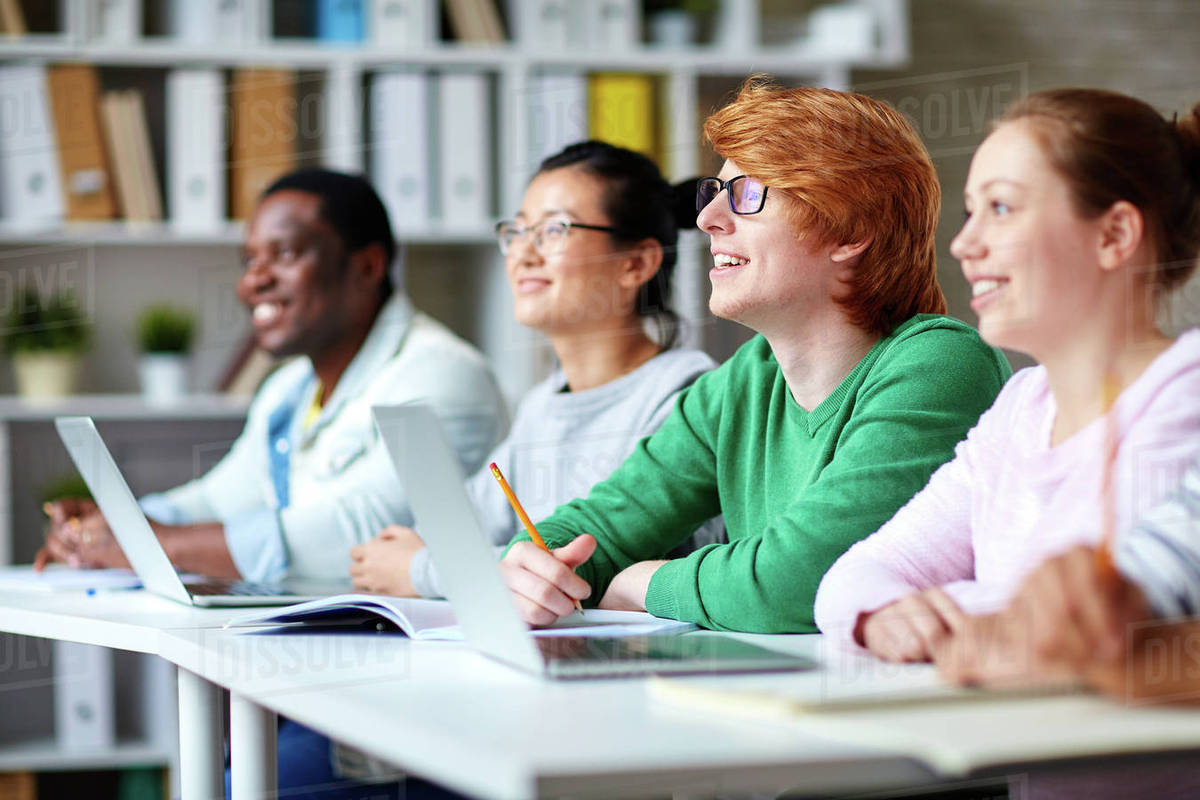Happy students listening to lecturer - Stock Photo - Dissolve