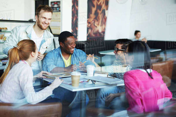 Group of students talking in college cafe - Royalty-free Stock Photo ...