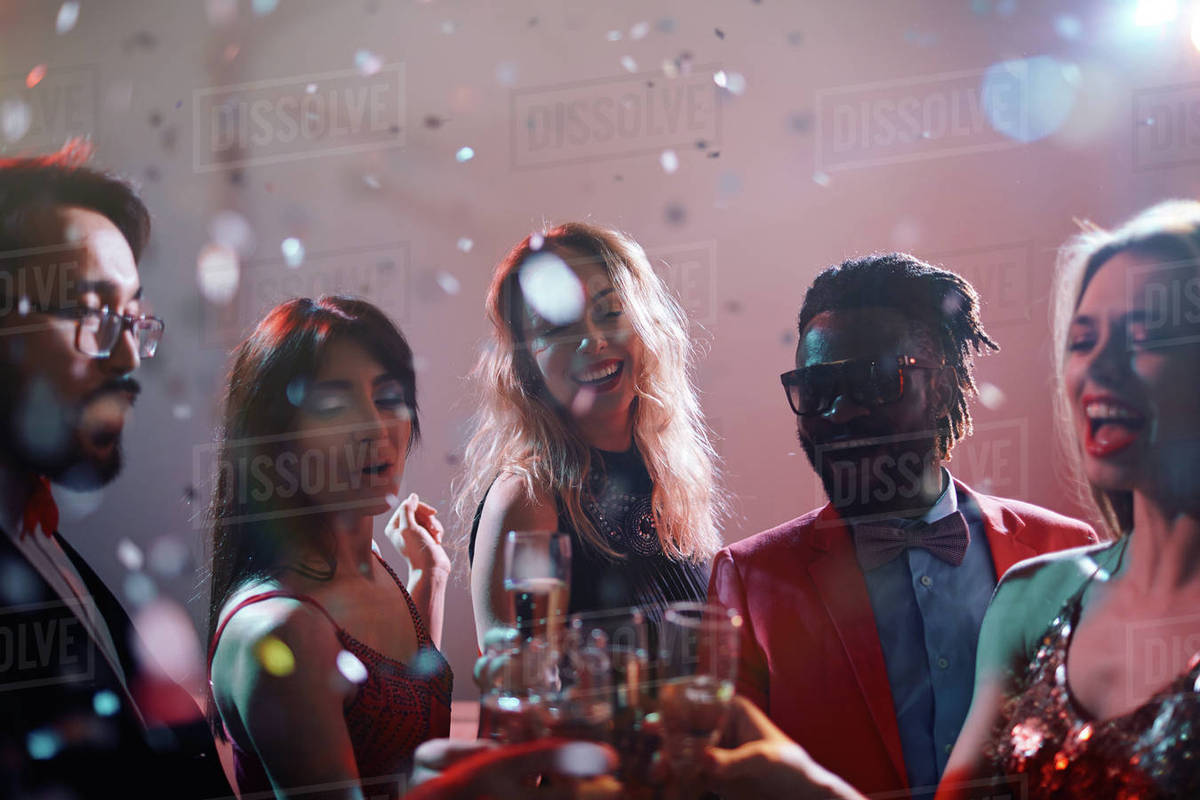Group of ecstatic friends toasting at party - Royalty-free Stock Photo ...
