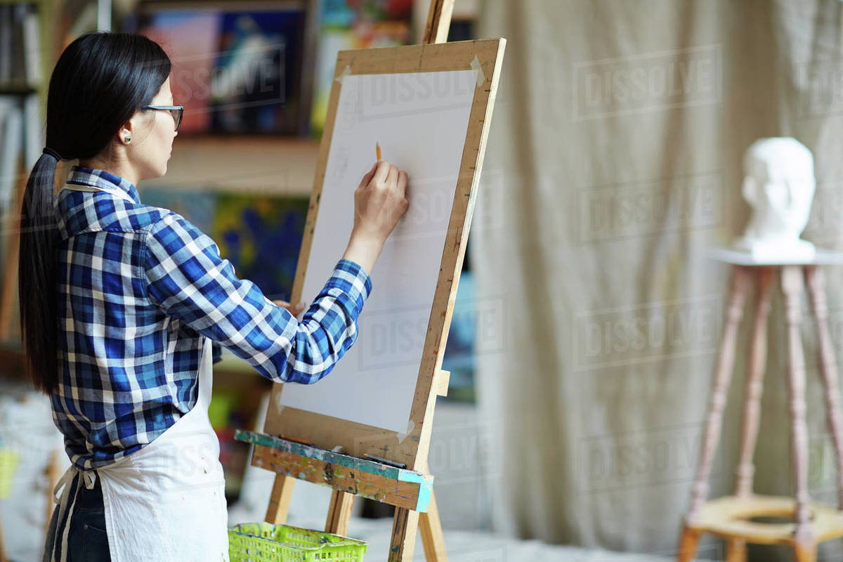 Young woman studying in art class - Royalty-free Stock Photo | Dissolve
