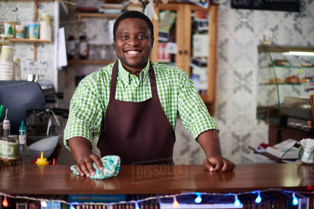 Portrait of a cheerful man working at bar counter - Stock Photo - Dissolve
