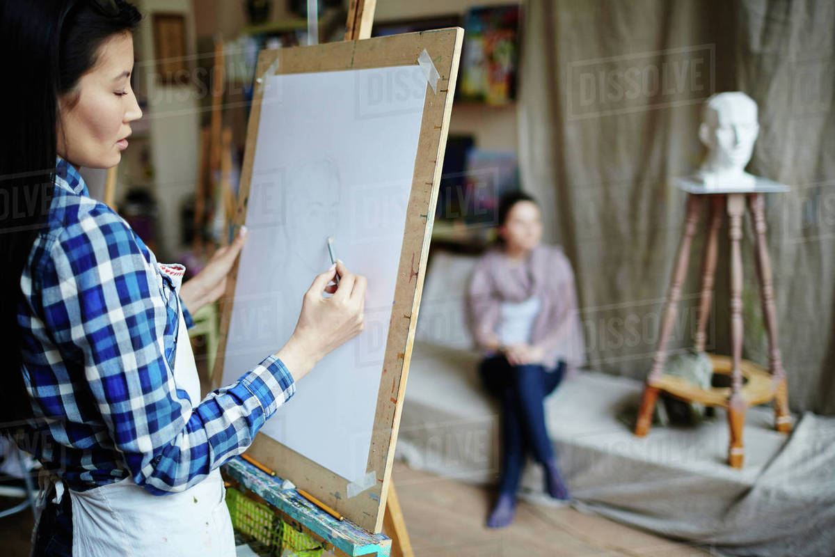 Young student drawing face of woman with pencil in workshop - Royalty ...