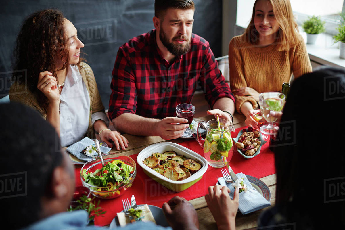 Group of friends having dinner - Royalty-free Stock Photo | Dissolve
