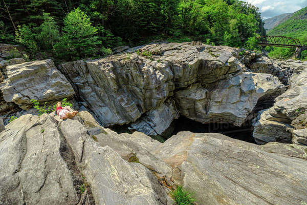Woman among gorges of canyon of Aussichtspunkt Ponte Brolla bridge in ...