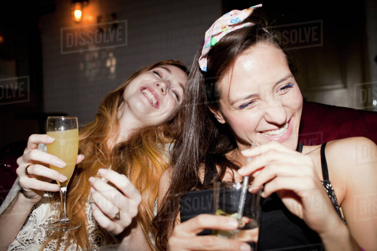 Happy young friends enjoying drinks at a bar - Royalty-free Stock Photo ...