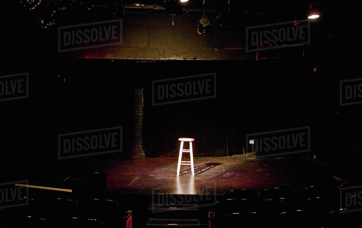 An empty stool spot lit on a stage - Royalty-free Stock Photo | Dissolve