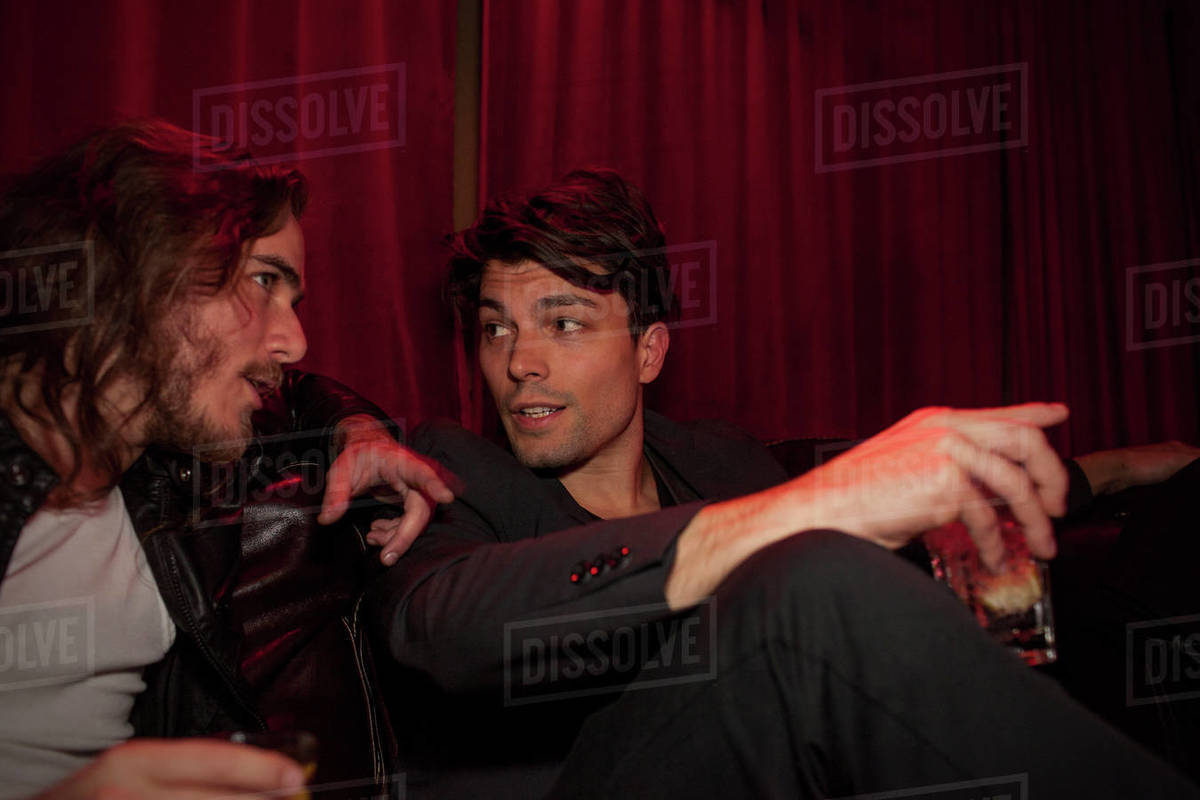 Young men hanging out at a nightclub - Stock Photo - Dissolve
