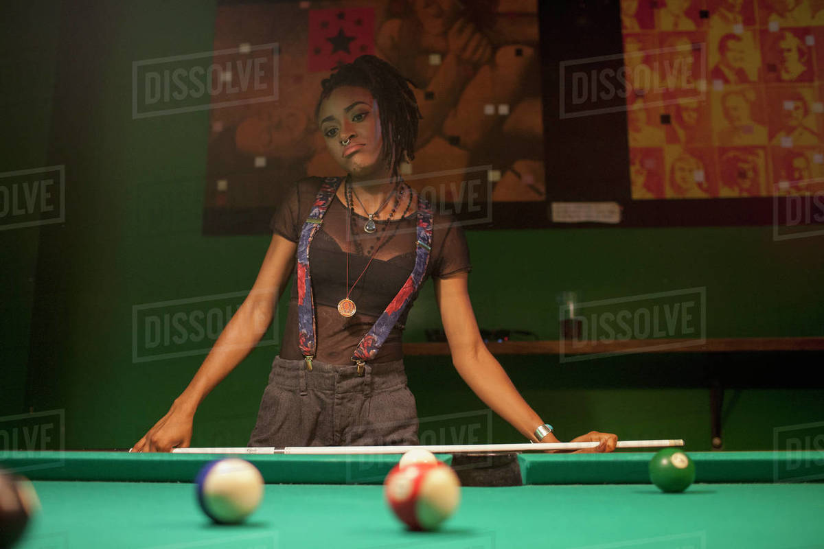 A young woman playing pool. - Royalty-free Stock Photo | Dissolve