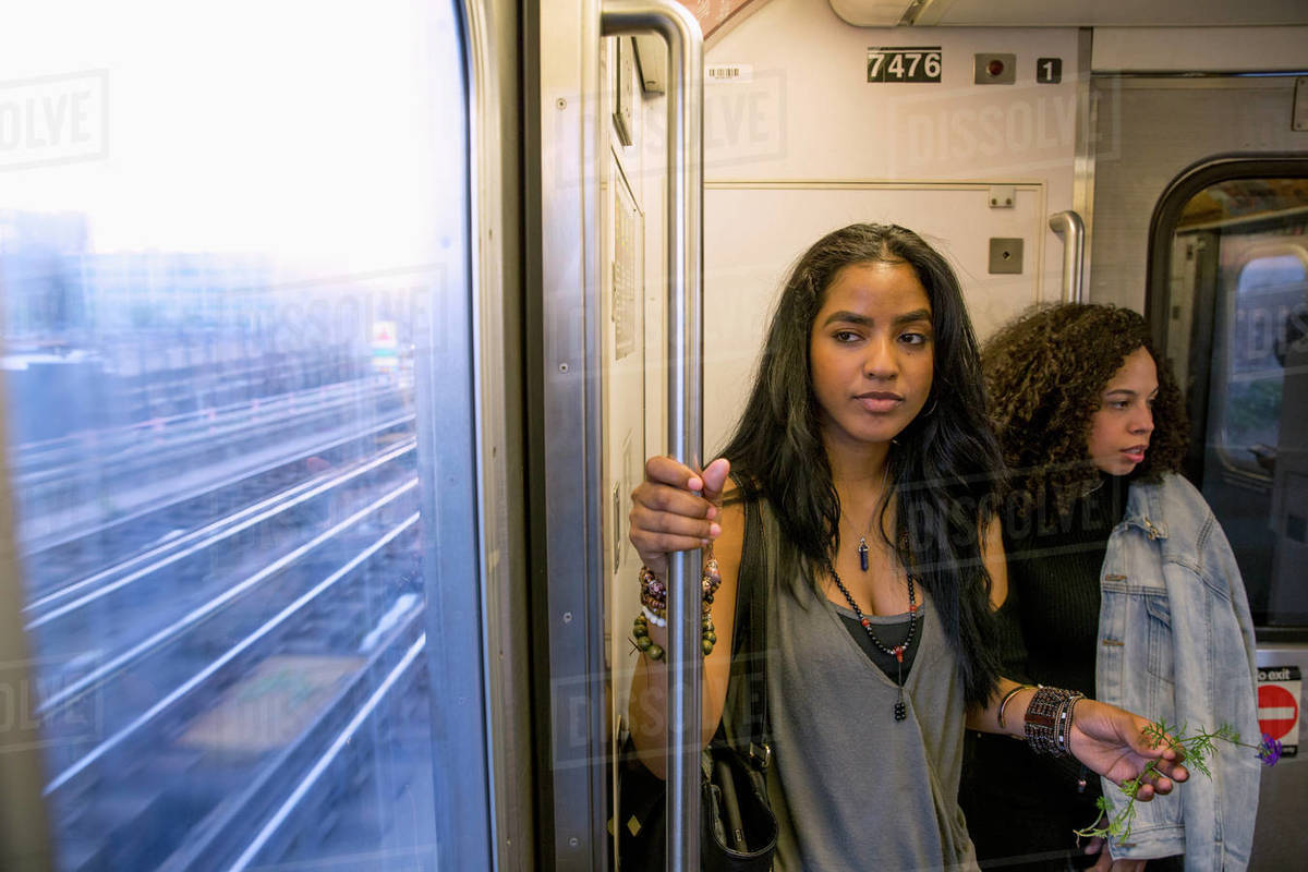 Friends commuting by train in Queens, New York - Royalty-free Stock ...