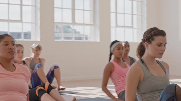 Yoga class group of young multiracial people practicing poses enjoying ...