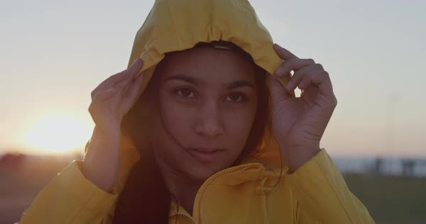 Close up portrait of teenage girl removing hood and looking confident ...