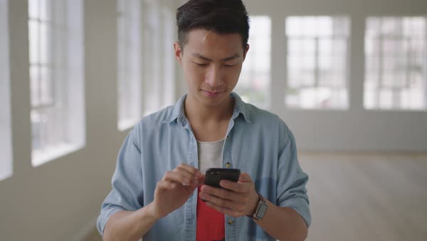 Portrait of handsome young asian man using smartphone - 4K Royalty-free ...