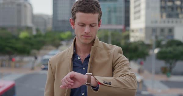 Portrait professional young man checking time on smart watch mobile ...