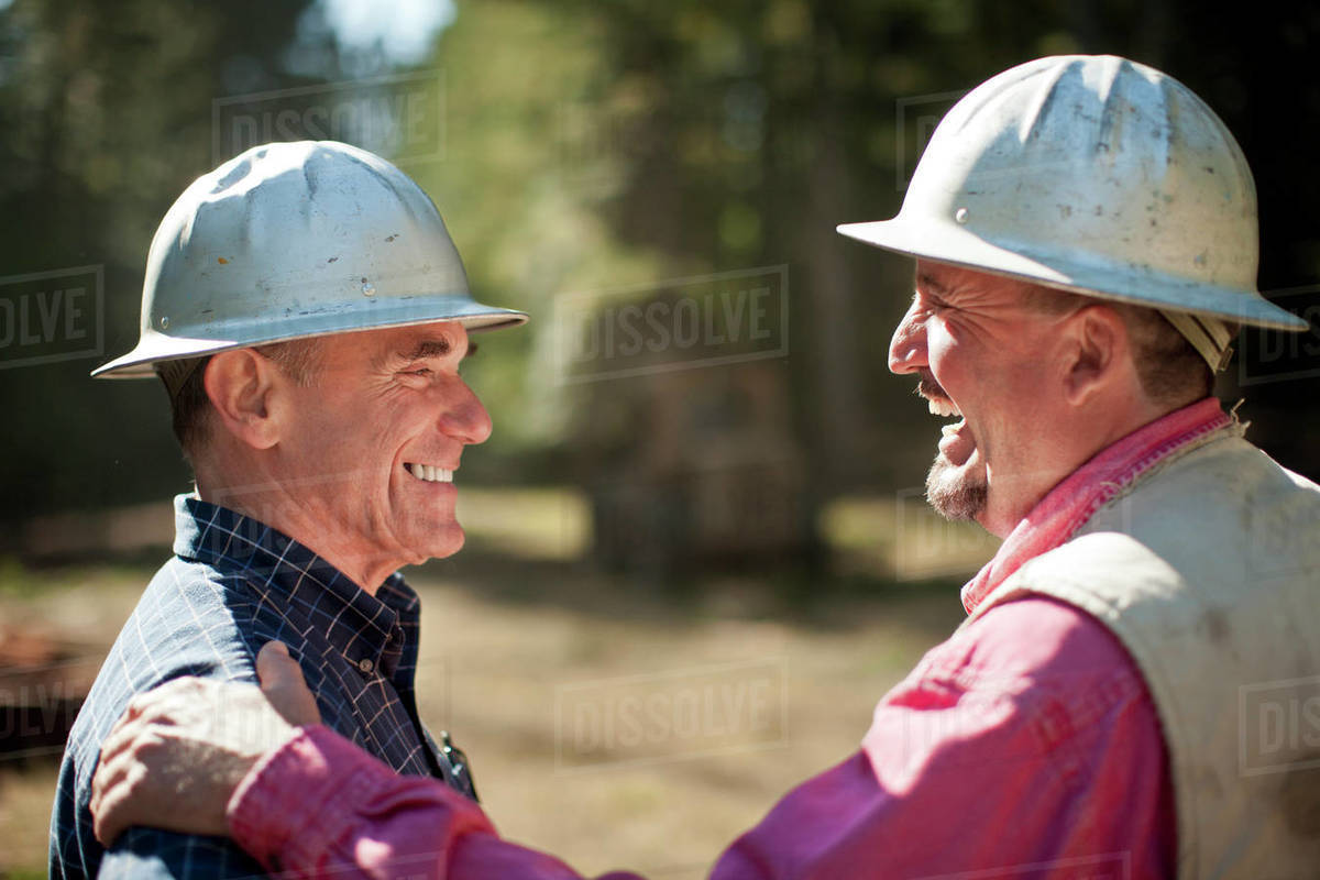 Two lumberjacks having a laugh in the forest. - Royalty-free Stock ...