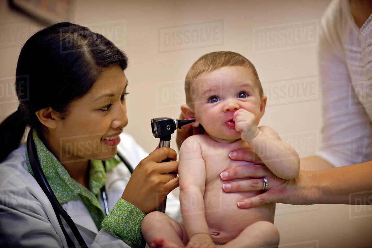 Doctor examining baby boy's ear with otoscope. - Royalty-free Stock ...