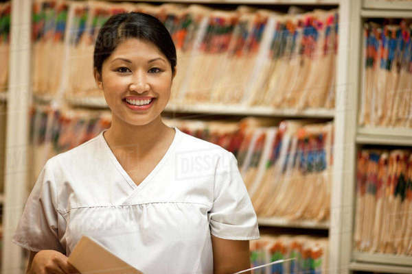 Portrait of nurse holding the folder in hospital office. - Stock Photo ...
