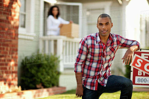 Portrait of mid-adult man standing outside their new home. - Royalty ...
