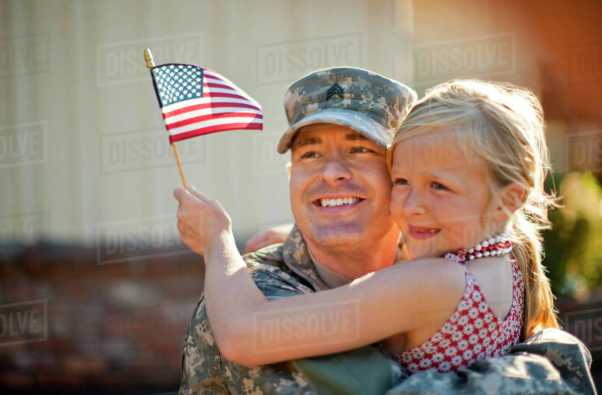 Smiling soldier hugging his young daughter. - Royalty-free Stock Photo ...