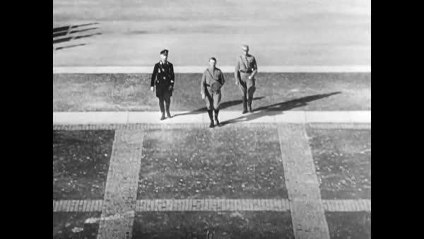 World War Two. Long shot of a stadium. Adolf Hitler walk through it ...
