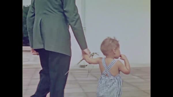 World War Two. Adolf Hitler in uniform walk with a little child to the ...