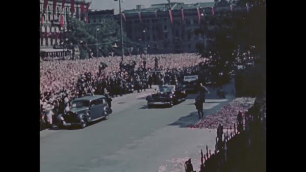 World War Two. A crowed stand in the streets of Berlin with flowers ...
