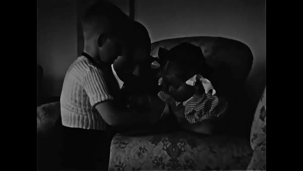 World War Two. Adolf Hitler sit on a sofa. Two childs are beside him. A ...