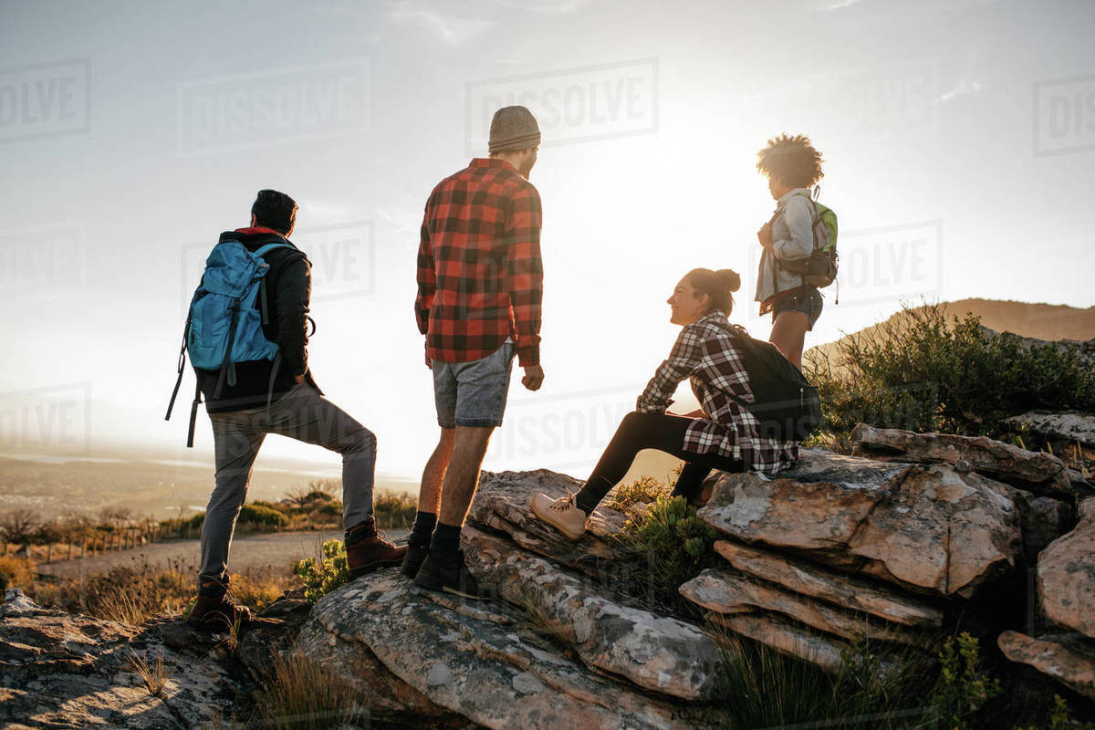 Group of hikers on top of hill and enjoying view. Young people hiking ...