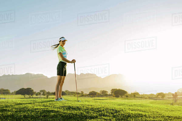 Full length of caucasian female golfer standing on golf course. Woman ...