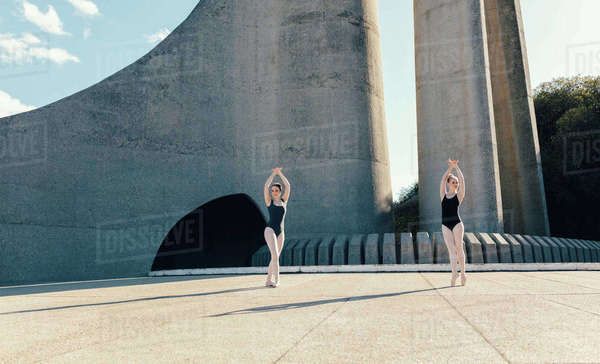 Ballet dancers practicing dance moves outdoors. Ballet dancers ...