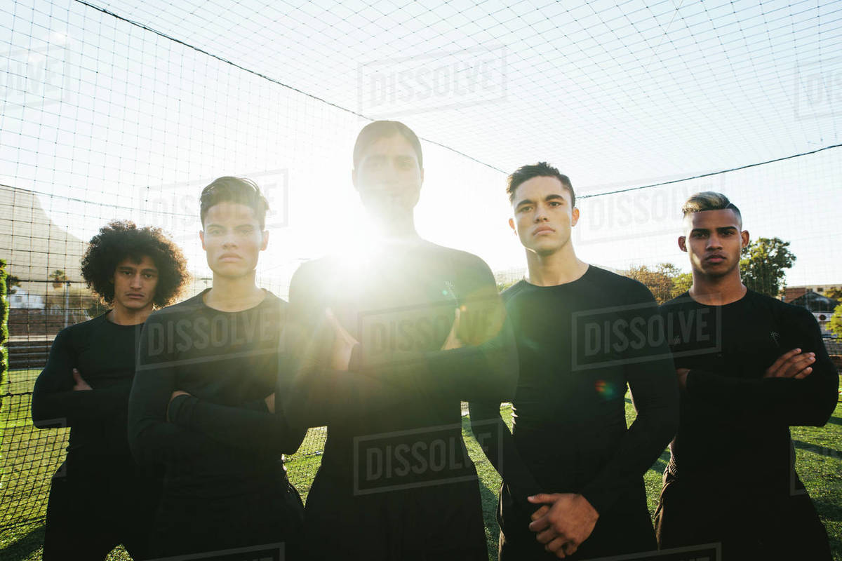 Young football team standing together in a line on soccer field ...