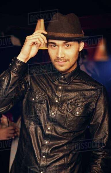 Portrait of a cute dude looking cool in black - Stock Photo - Dissolve