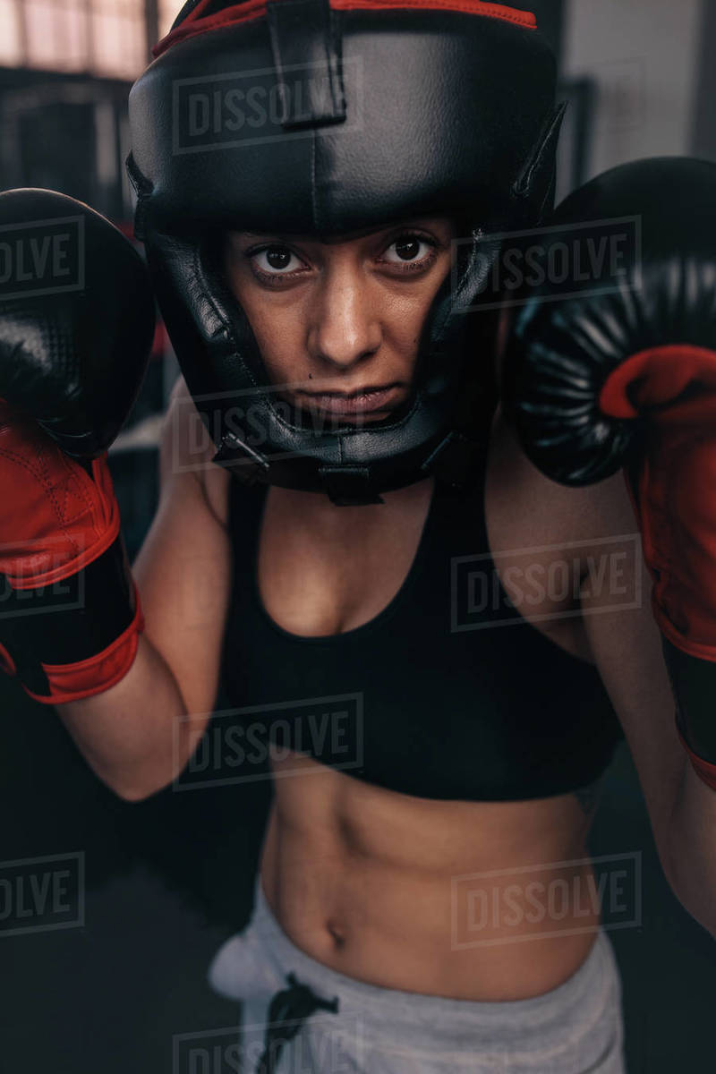 Close up portrait of a female boxer in her boxing gear. Woman boxer at ...