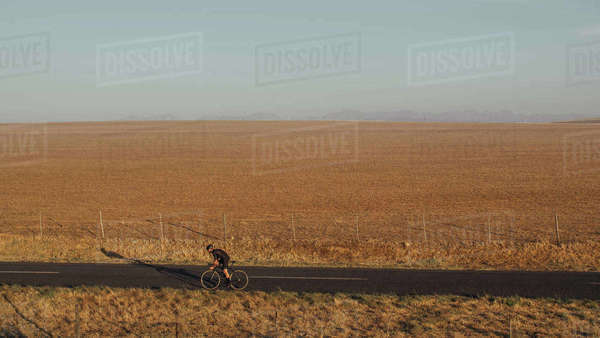 Aerial view of professional cyclist riding a bike on asphalt road. Male ...