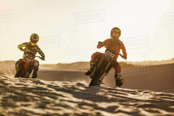 Two motocross racers racing on the off-road circuit. Professional dirt ...