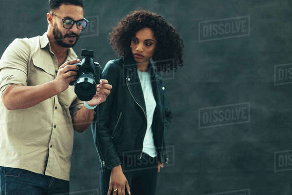 Photographer discussing a point with a female model during a photo ...