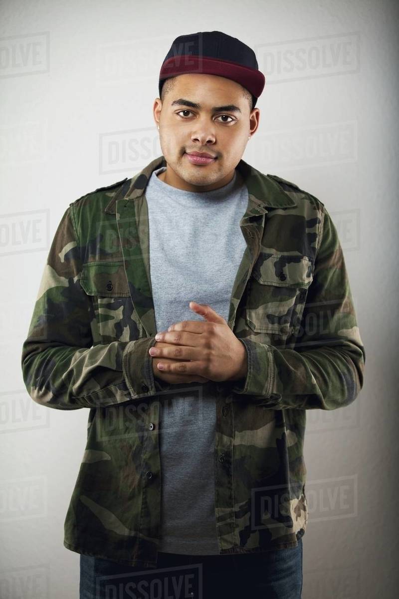 Handsome male fashion model posing in casual wear on grey background ...