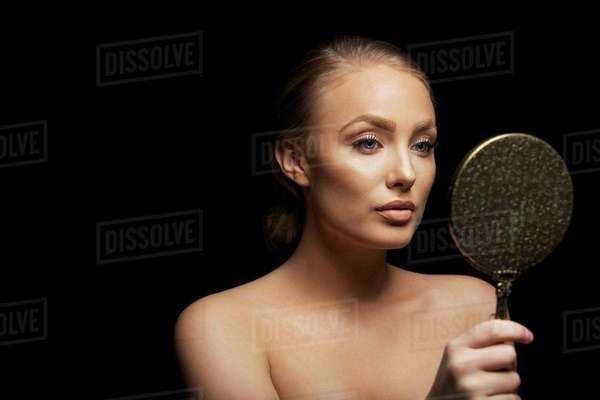 Sensual young female model looking in hand mirror. Beautiful young girl ...