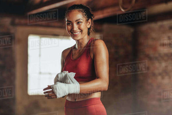 Woman boxer wearing strap on wrist for boxing practice. Fitness female ...