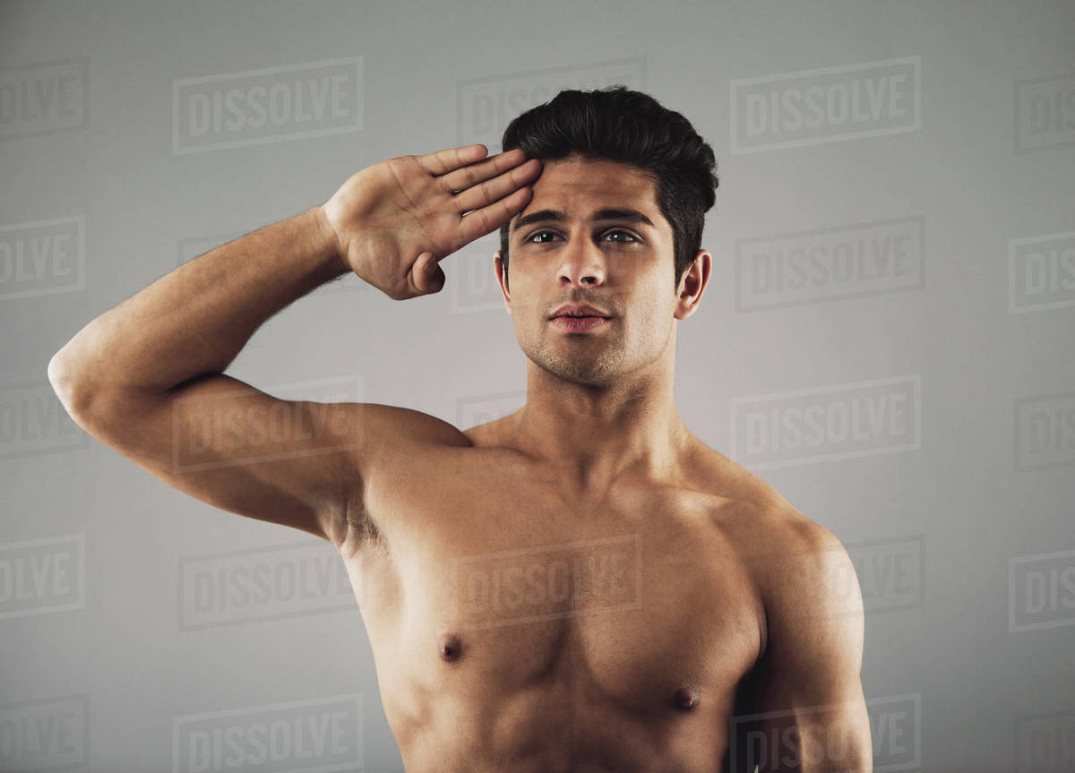 Portrait of handsome male doing a salute. Shirtless hispanic young guy ...