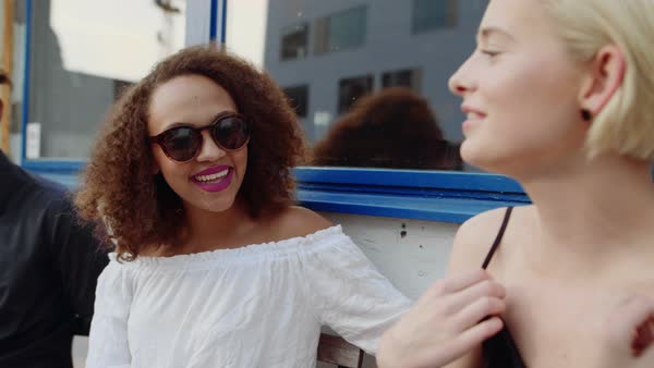 Best friends walking on city street at night and celebrating with ...