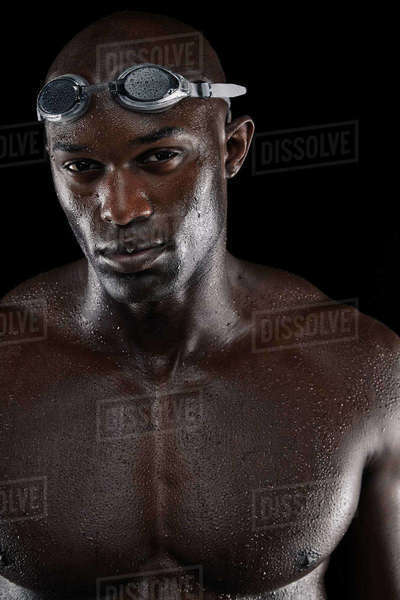 Determined swimmer with wet body looking at camera. Portrait of young ...