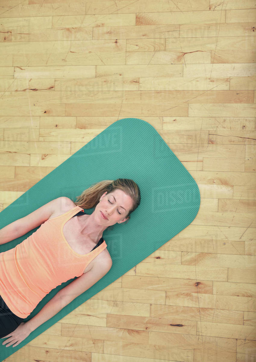 Top view of woman relaxing on yoga mat with copy space. Fitness female ...