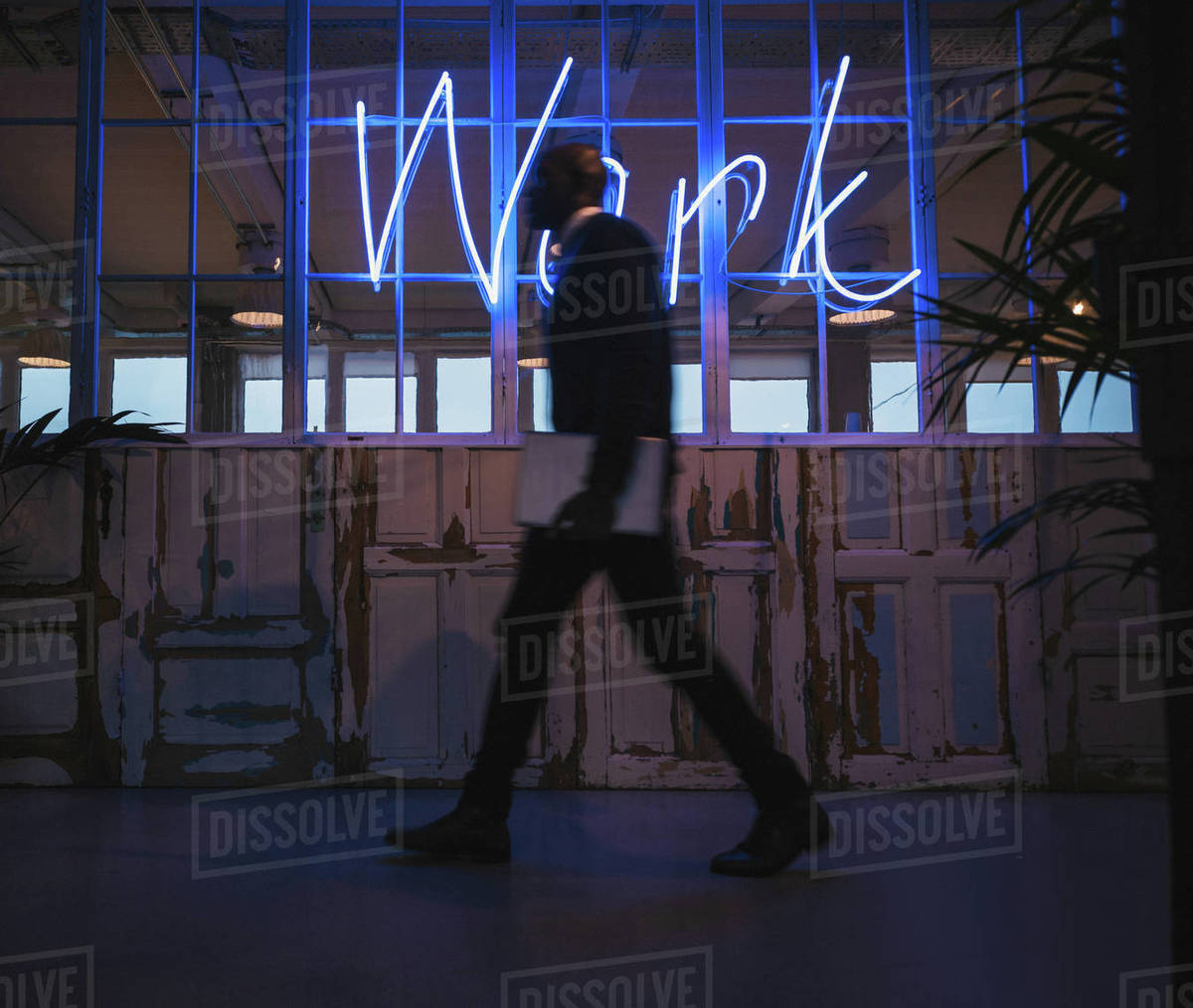 Neon light work sign in corridor of a modern office with a executive ...