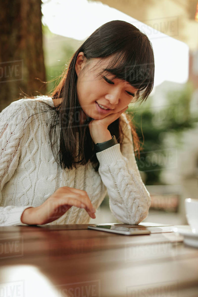 Beautiful chinese woman using cellphone at outdoor cafe. Asian female ...