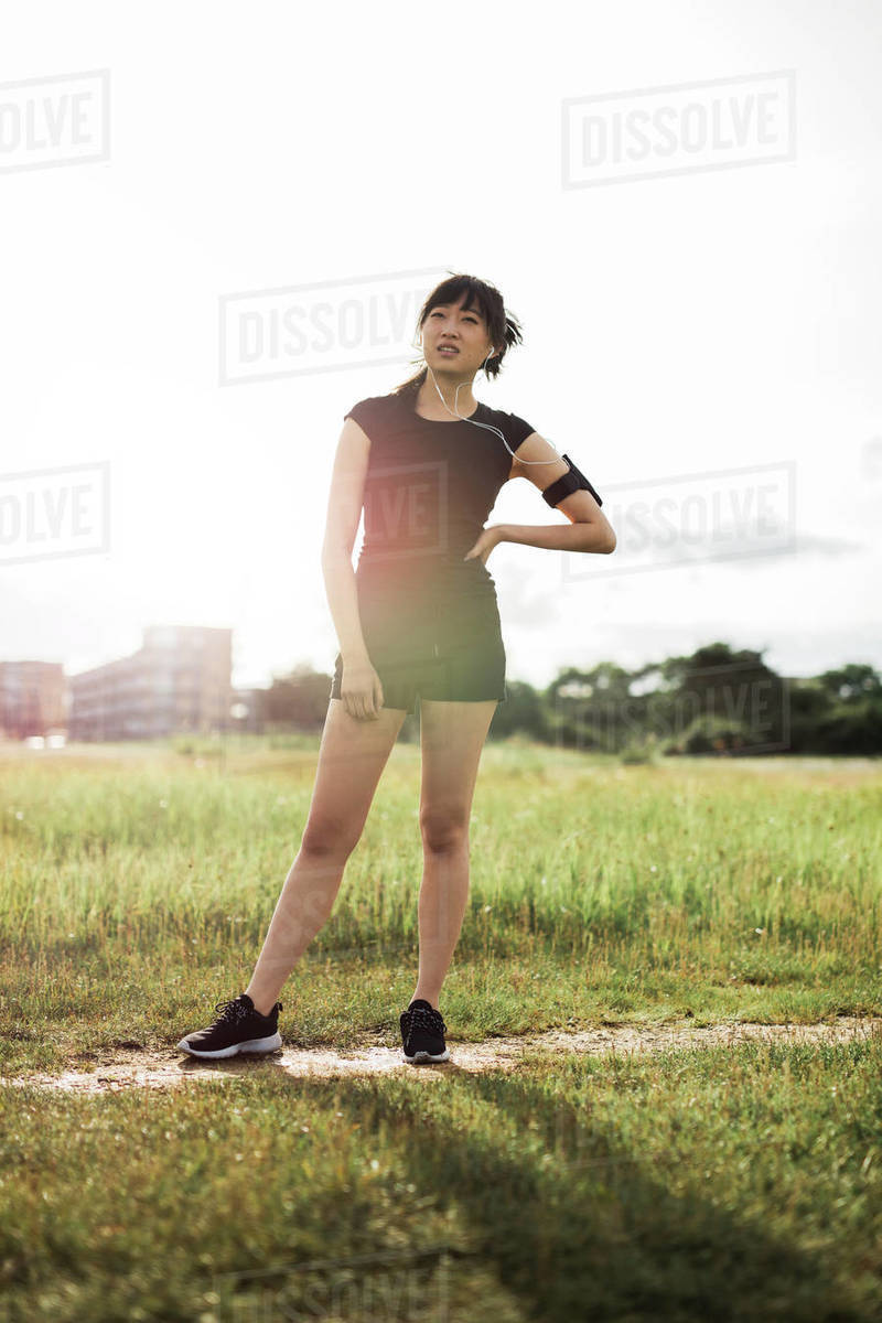 Full length portrait of a fit and healthy young woman runner standing ...